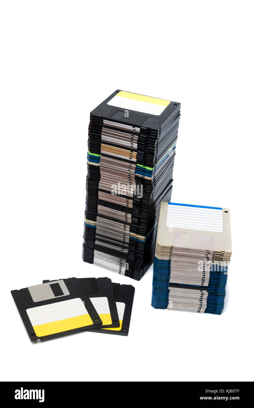 Vertical pile of computer floppy disks isolated on a white background ...