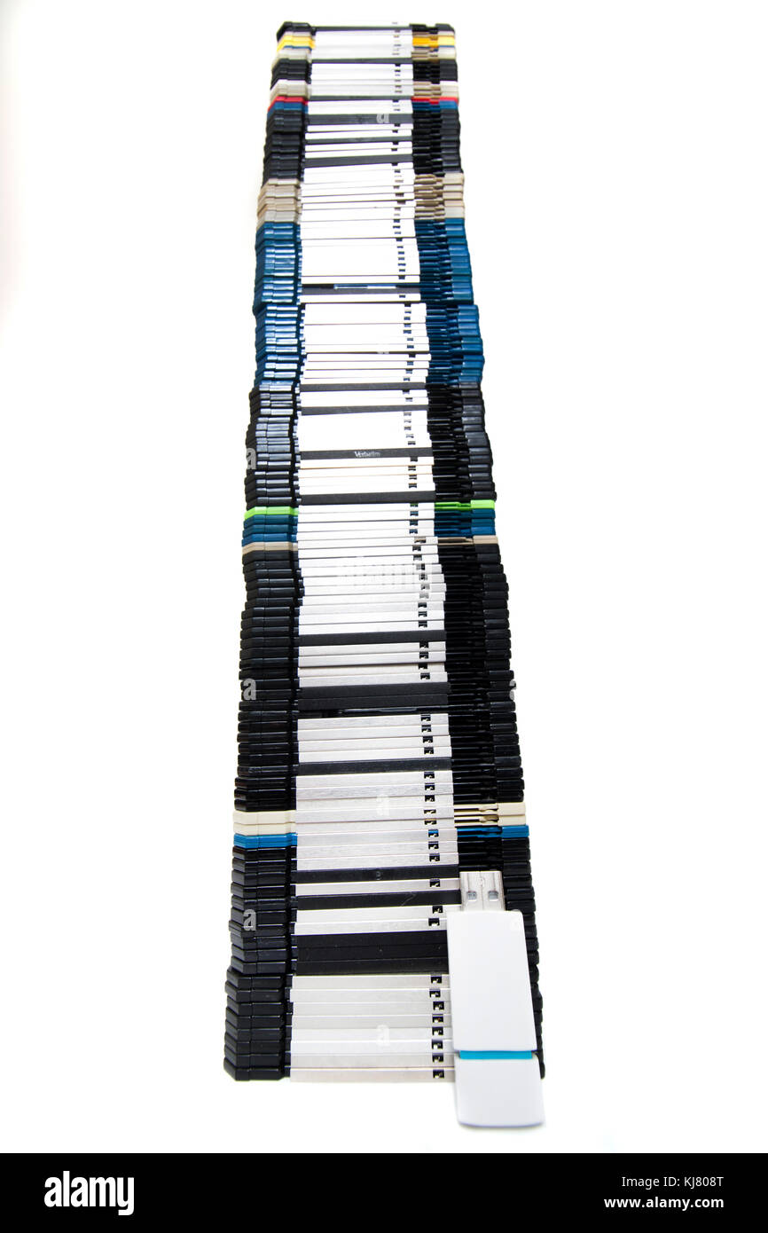 Vertical pile of computer floppy disks with usb disk isolated on a ...