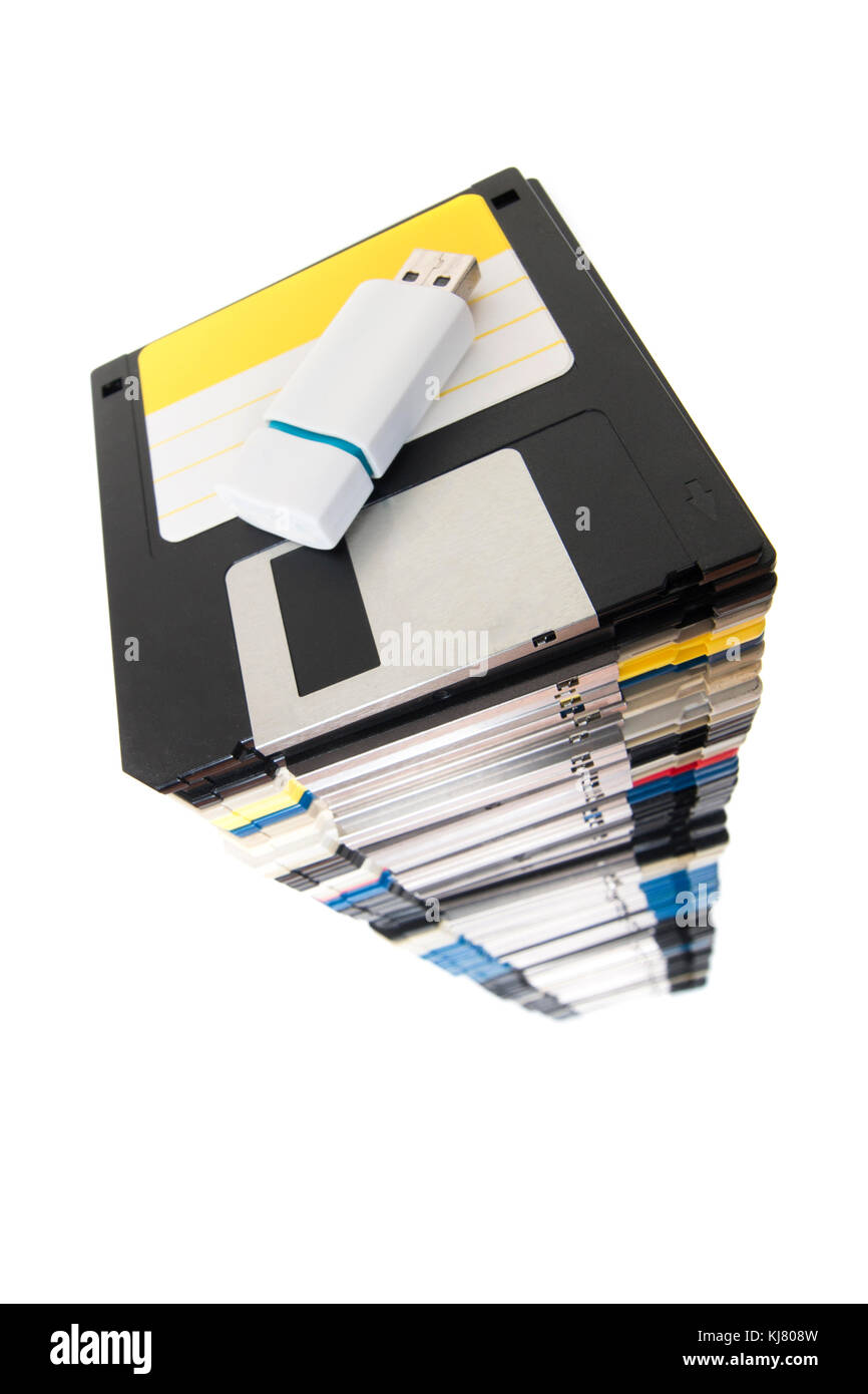 Vertical pile of computer floppy disks with usb disk isolated on a ...