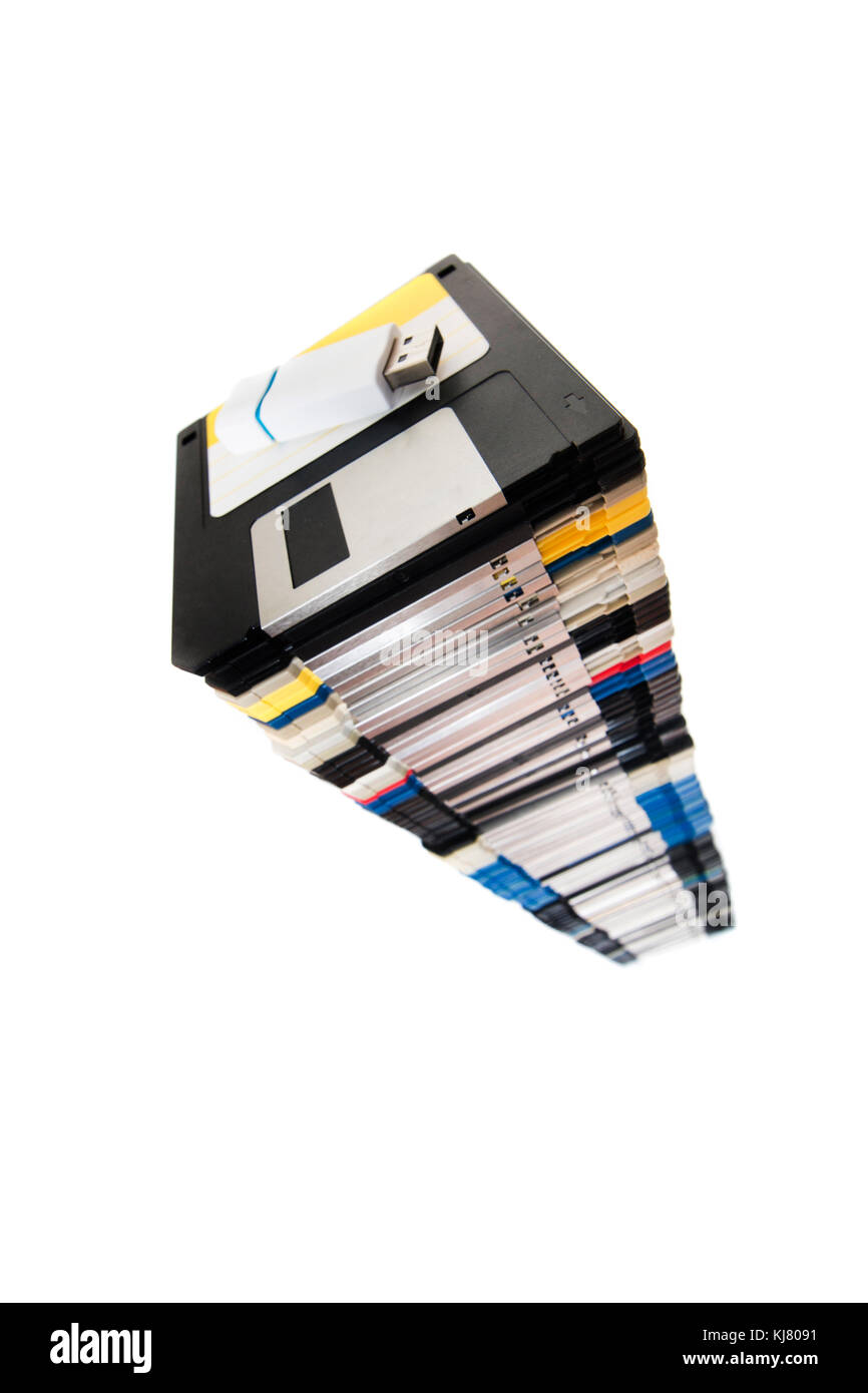 Vertical pile of computer floppy disks with usb disk isolated on a ...
