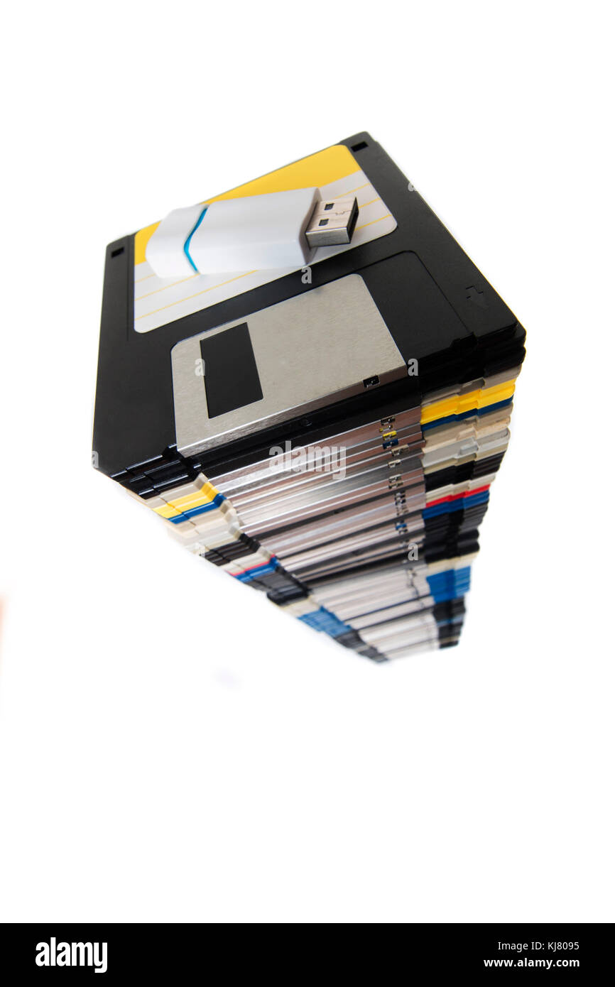 Vertical pile of computer floppy disks with usb disk isolated on a ...