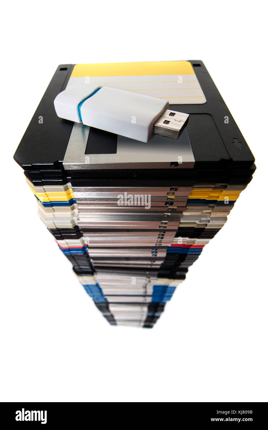 Vertical pile of computer floppy disks with usb disk isolated on a ...