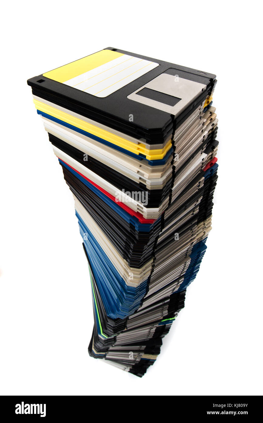 Vertical pile of computer floppy disks isolated on a white background ...