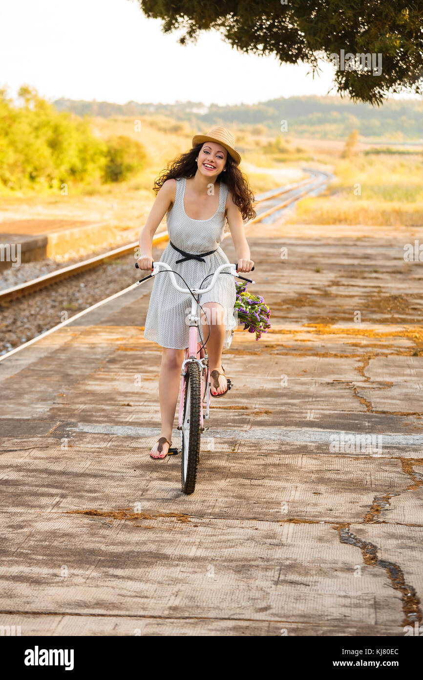 A beautiful young woman riding her bicycle Stock Photo - Alamy