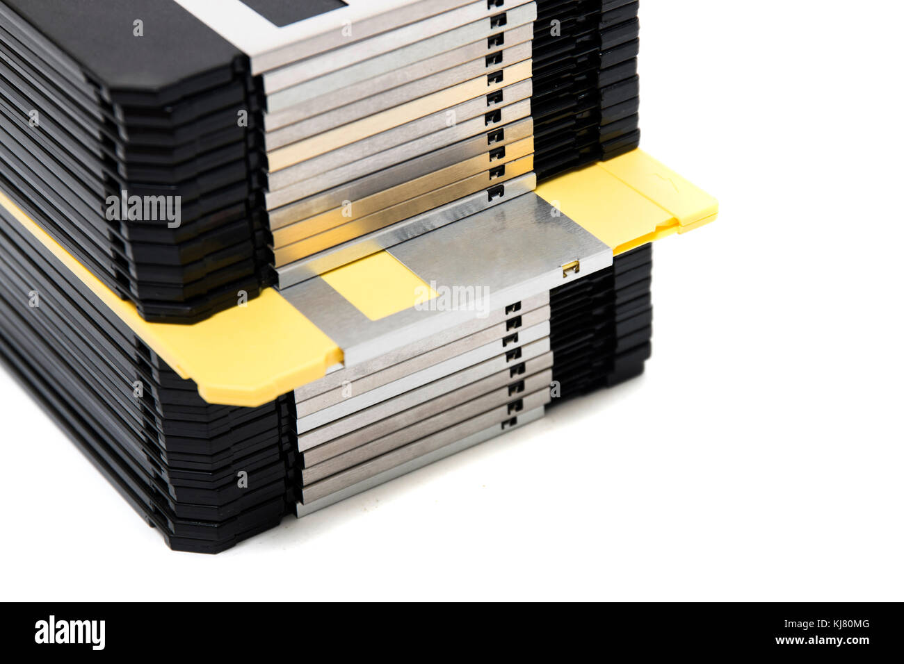 Vertical pile of computer floppy disks isolated on a white background ...