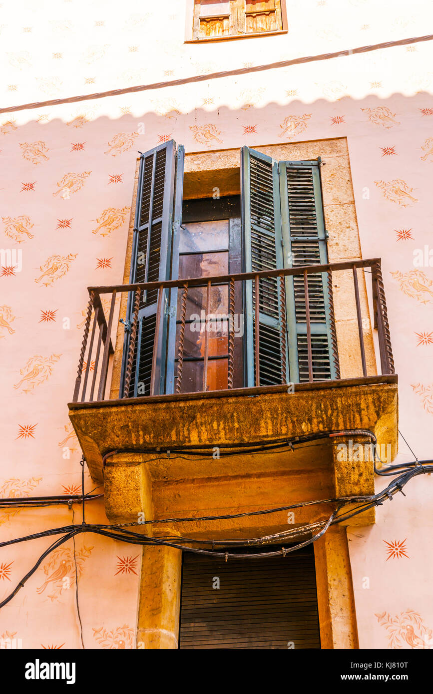 Stylish balcony with a metal railing, solid architectural element, a ...