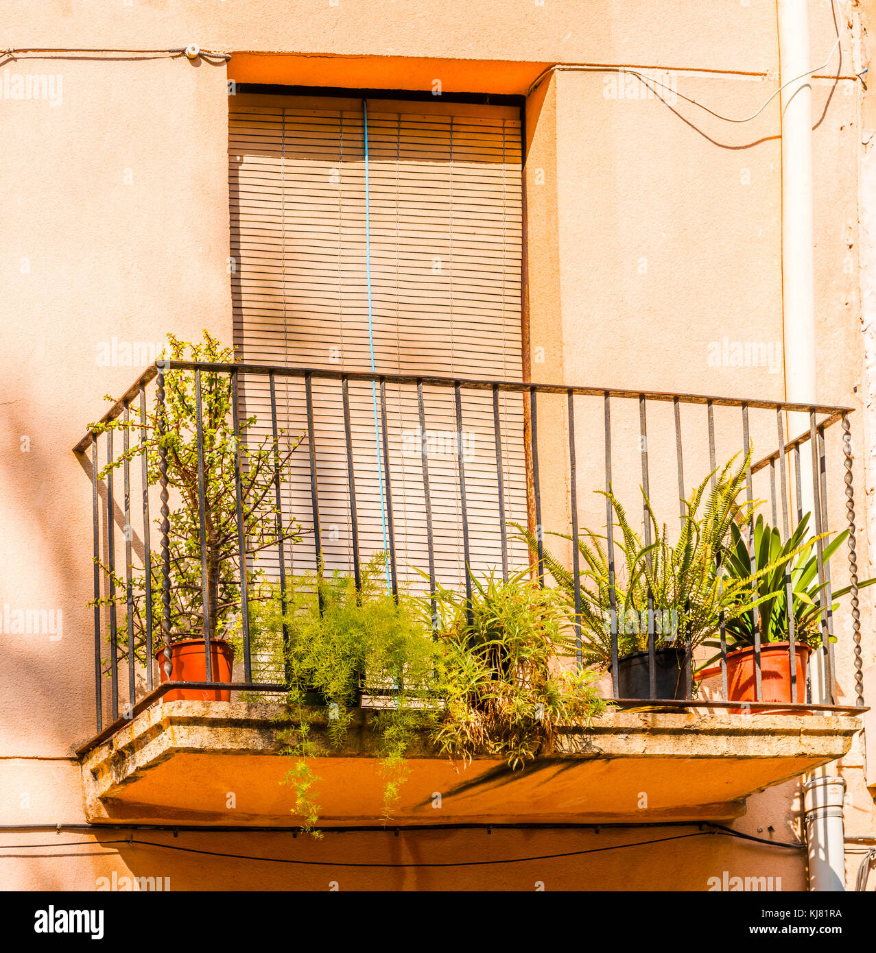 Stylish balcony with a metal railing, solid architectural element, a ...