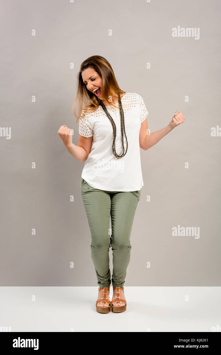 Beautiful young happy woman with arms up Stock Photo - Alamy