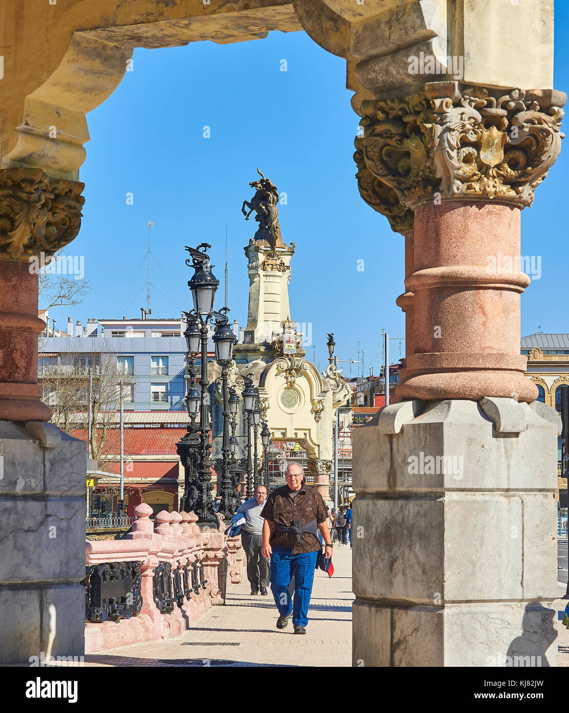 People crossing Maria Cristina bridge of San Sebastian. Basque Country ...