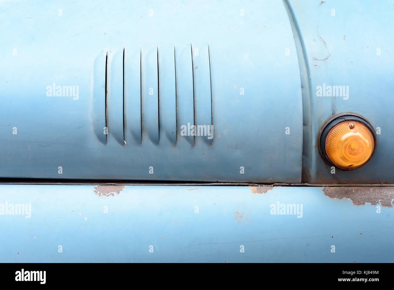 Old blue vintage indicator lamp on the side of a classic SUV Niva ...