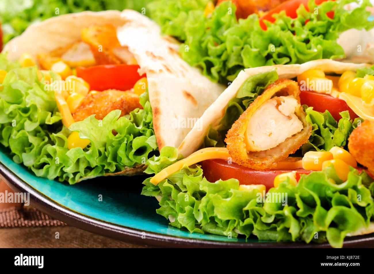 Selective focus on the right chicken wrap Stock Photo - Alamy
