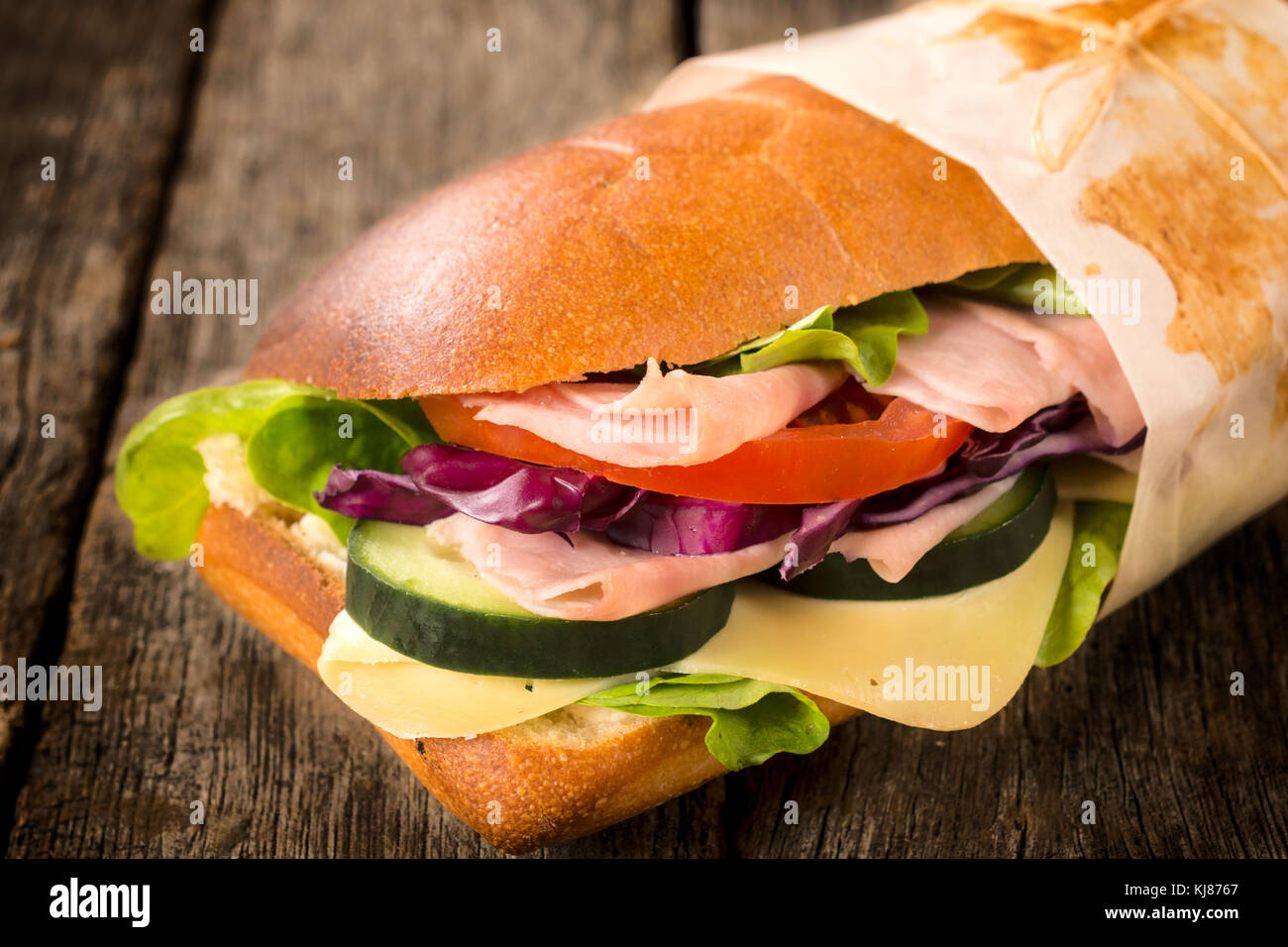 Single sandwich stuffed with cheese and ham Stock Photo - Alamy
