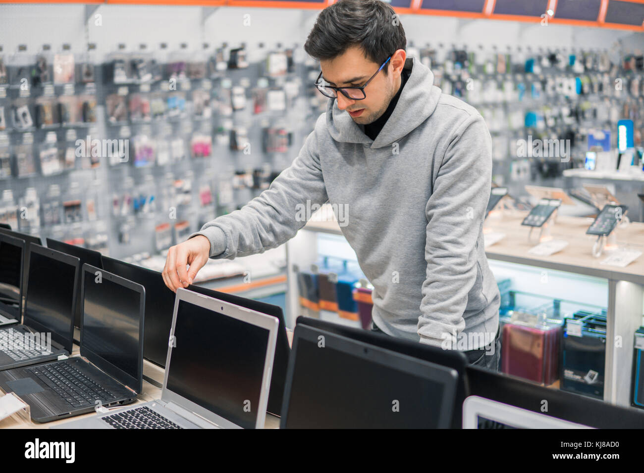 modern male customer choosing laptop in the computer shop Stock Photo ...