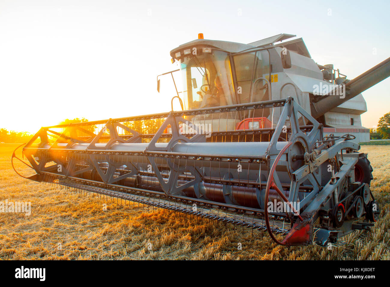 combine harvester working on a wheat field Stock Photo - Alamy