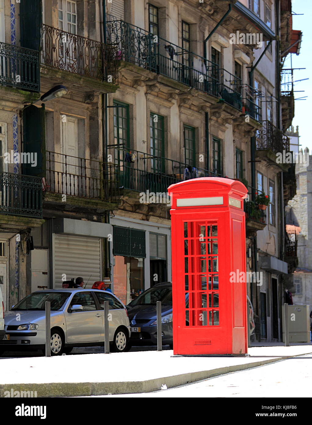 A red phone booth in the old town of Porto, Portugal Stock Photo - Alamy