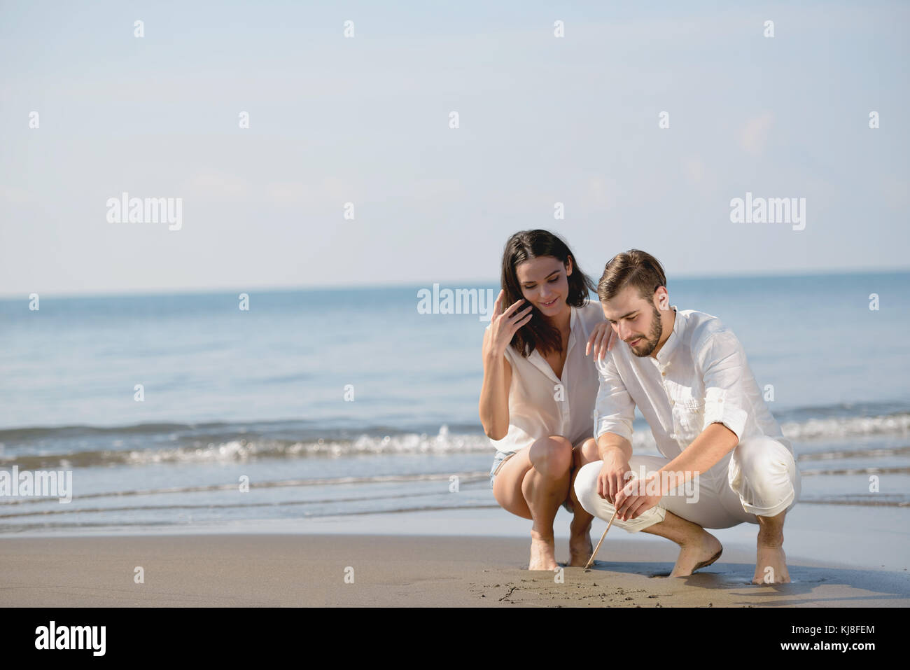 Couple writing sand hi-res stock photography and images - Alamy