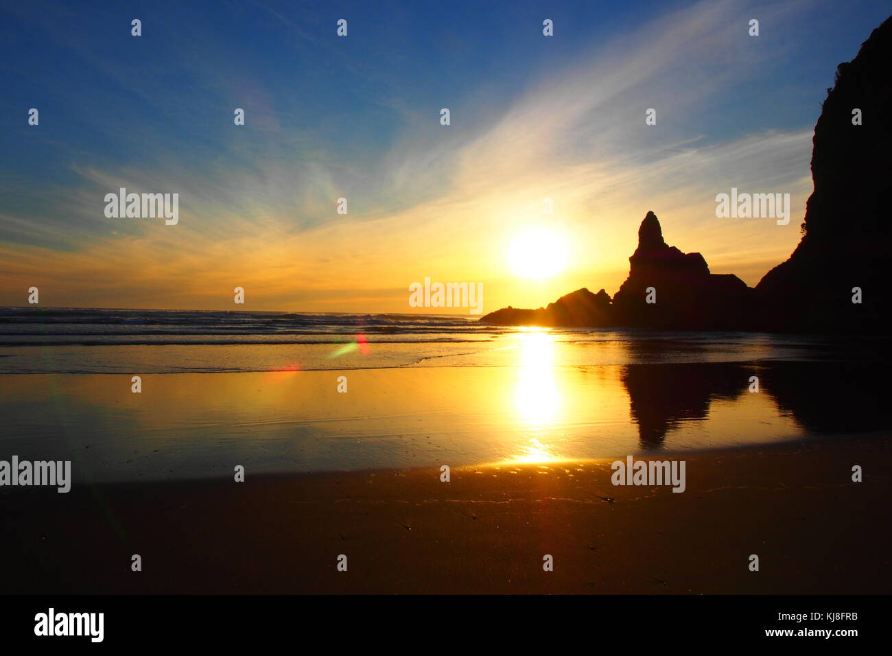 sunset at piha beach, new zealand Stock Photo - Alamy