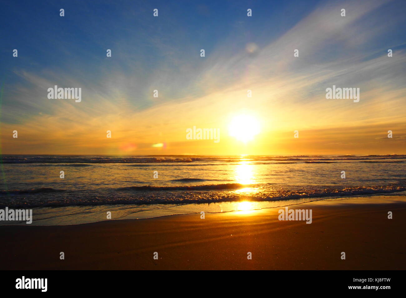 sunset at piha beach, new zealand Stock Photo - Alamy