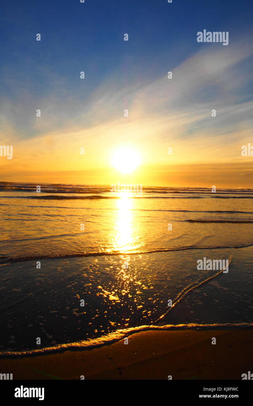 sunset at piha beach, new zealand Stock Photo - Alamy