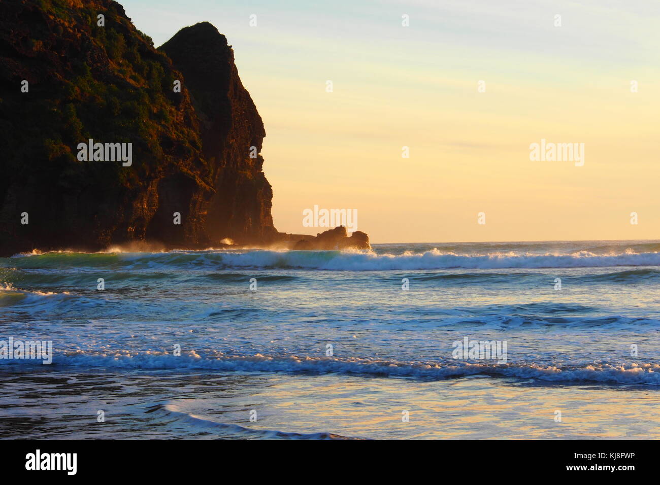 sunset at piha beach, new zealand Stock Photo - Alamy