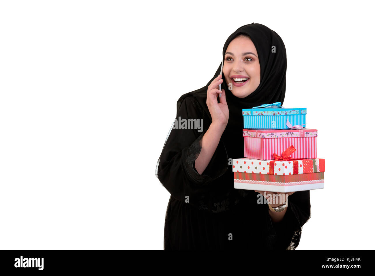 Happy young muslim woman with shopping bag and gift boxes isolated over ...