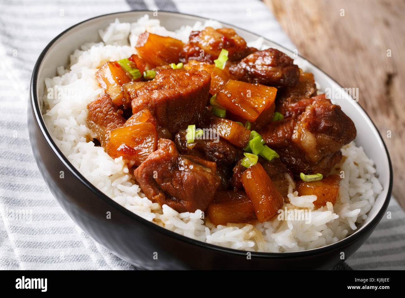 Filipino belly pork hamonado with pineapple and rice close-up in a bowl ...