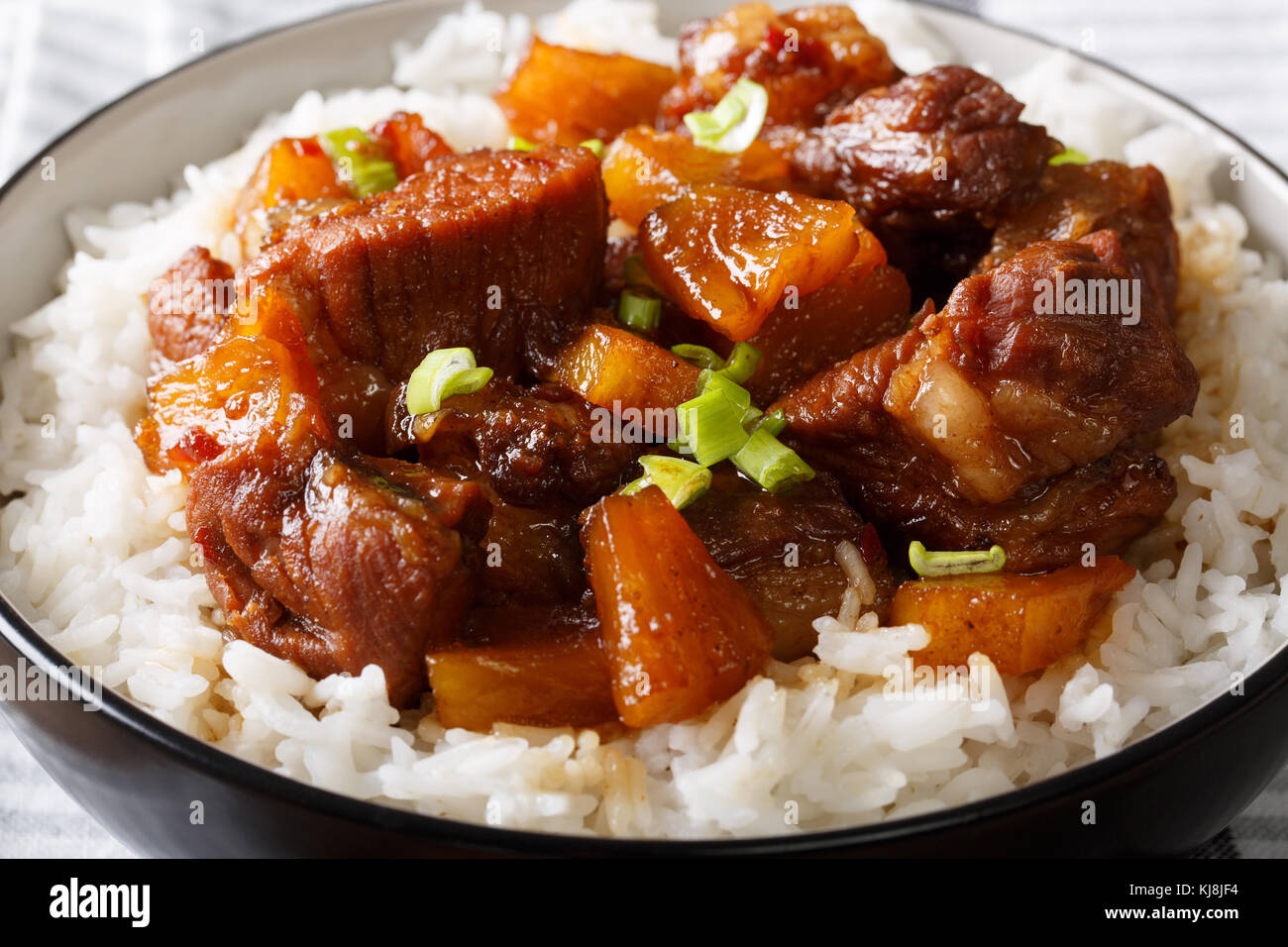 Filipino festive meal: Hamonado pork with pineapple and garnish of rice ...