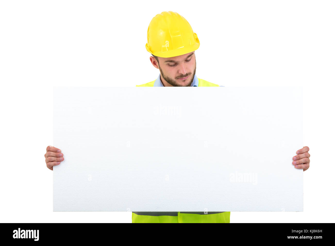 Happy male engineer holding an advertisement blank banner. Isolated on ...