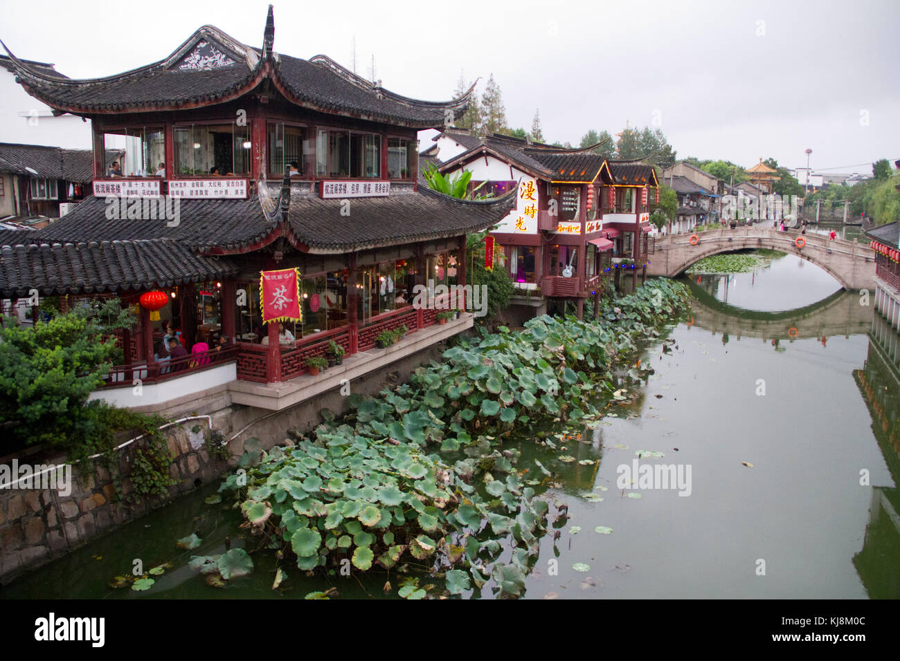 People walk past waterways in the ancient settlement of Qabio in the ...