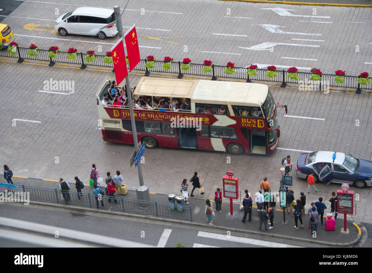 People wait at a bus stop near People's Square Park in central Shanghai ...