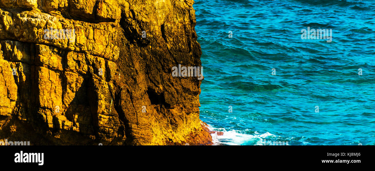 high cliff above the sea, summer sea background, many splashing waves ...