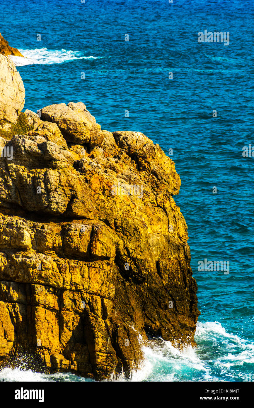 high cliff above the sea, summer sea background, many splashing waves ...