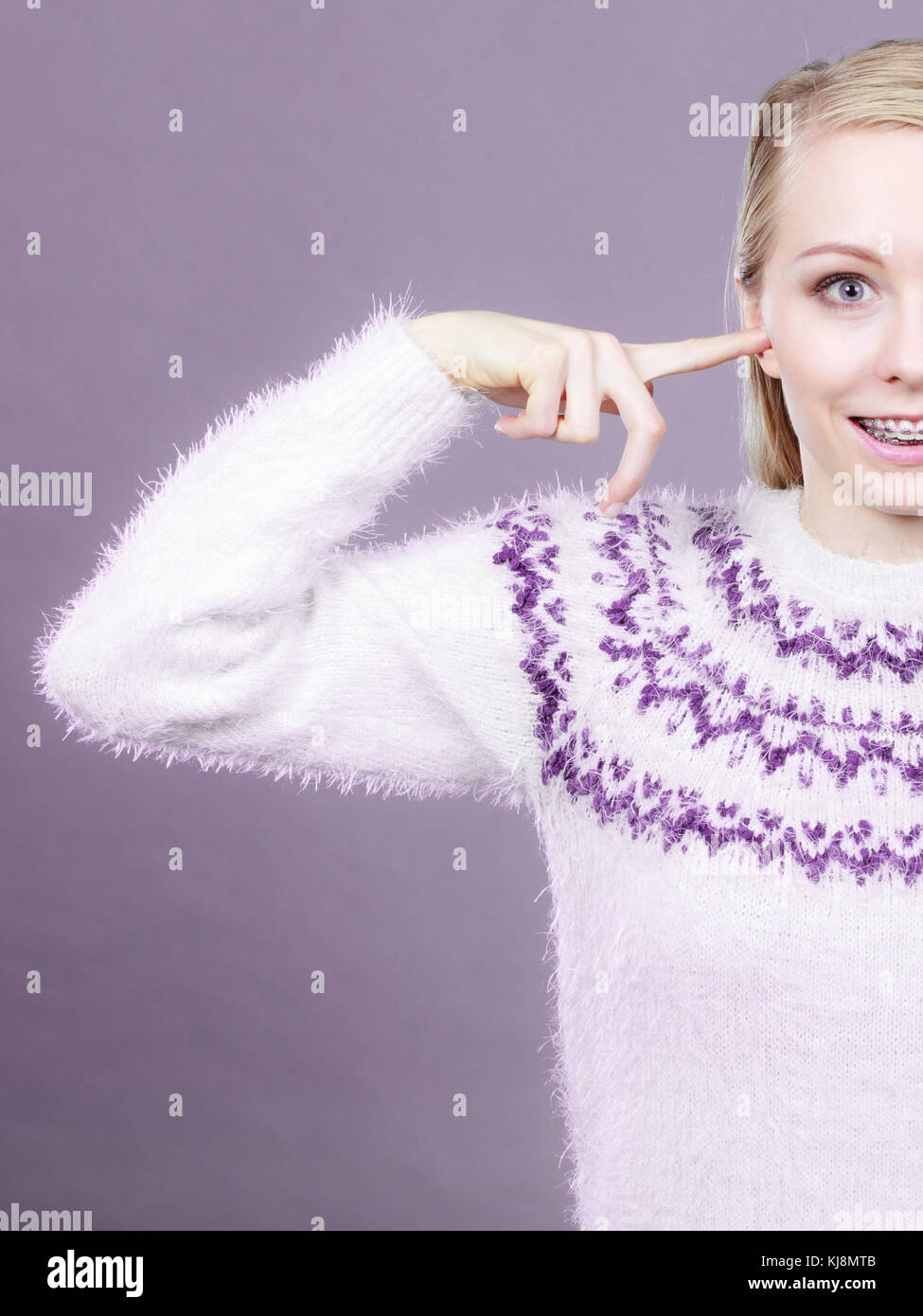 Hearing problems concept. Happy young blonde woman covering ears with ...