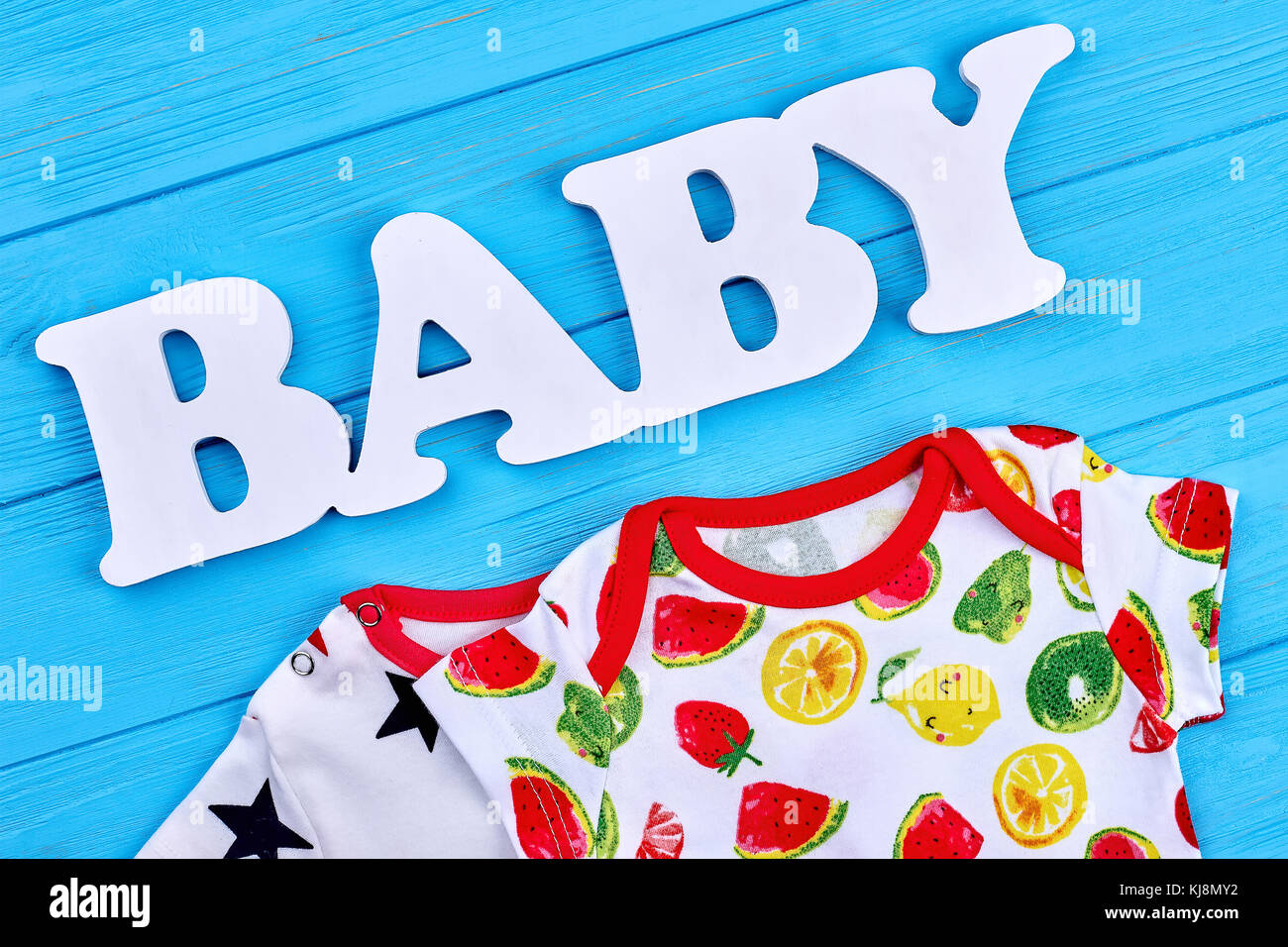 Fruit print cotton baby clothes. Close up of natural infant baby ...