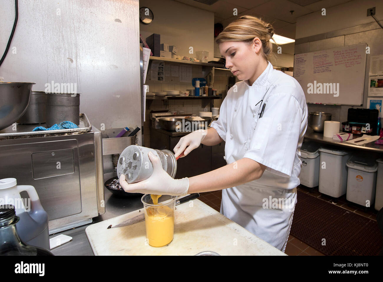 Navy Petty Officer 2nd Class Sierra Tyler prepares dinner for the USO ...