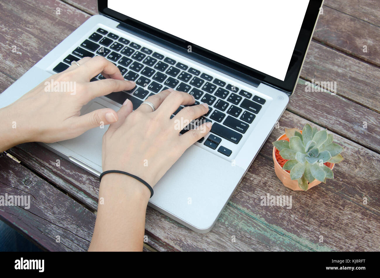 woman hands on a laptop at wood table Stock Photo - Alamy