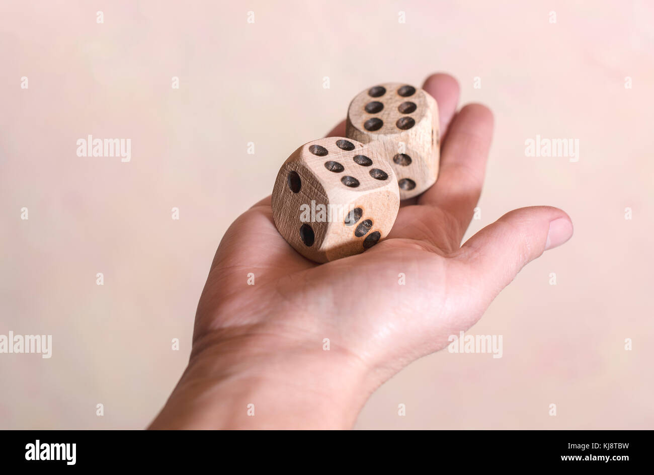 Wooden dice. Dices in hand shows six Stock Photo - Alamy