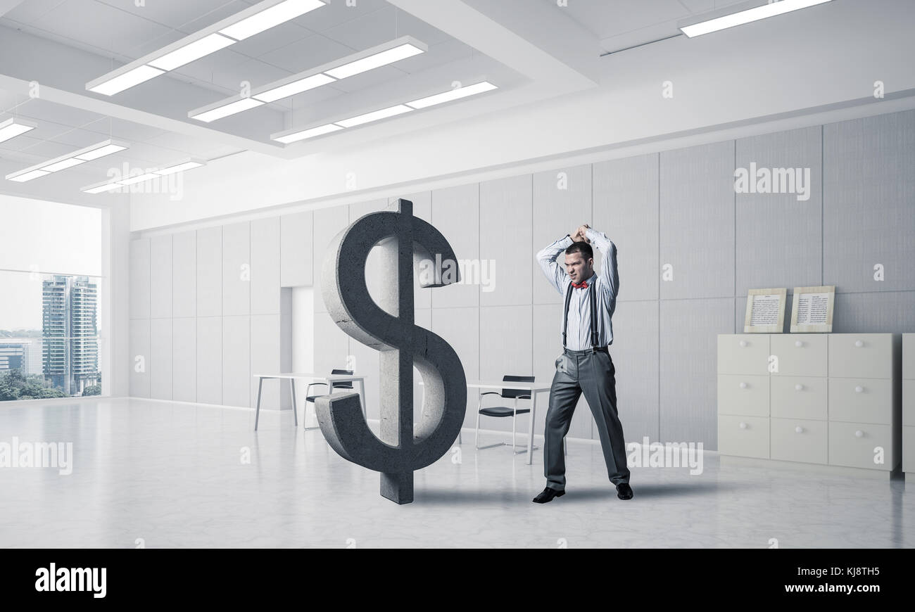Determined banker man in modern office interior breaking dollar Stock ...