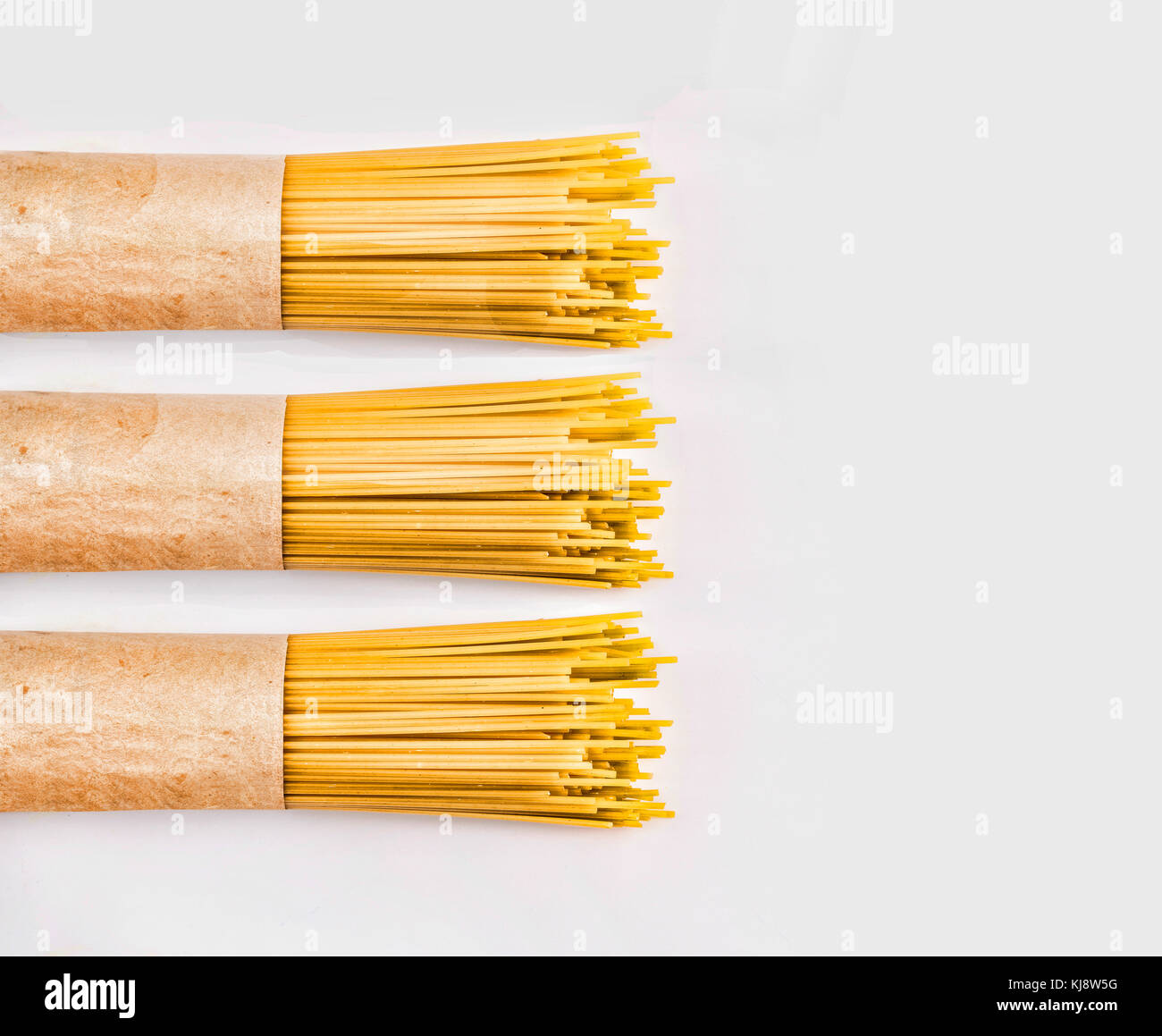 Spaghetti packed into paper on a white background. Supermarket. top ...