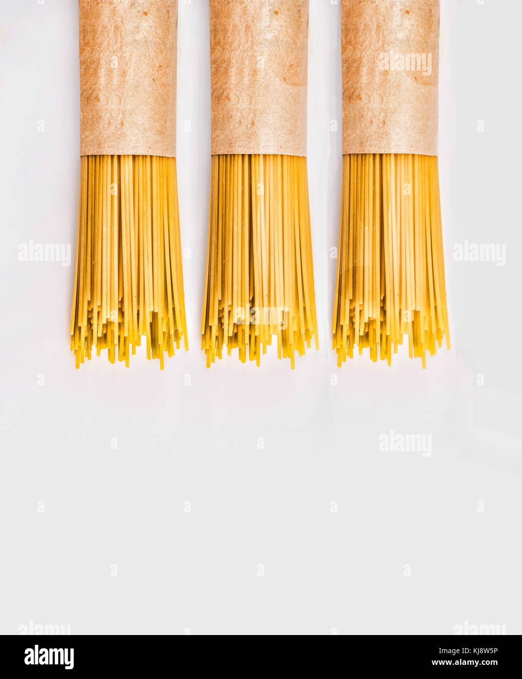 Spaghetti packed into paper on a white background. Supermarket. top ...