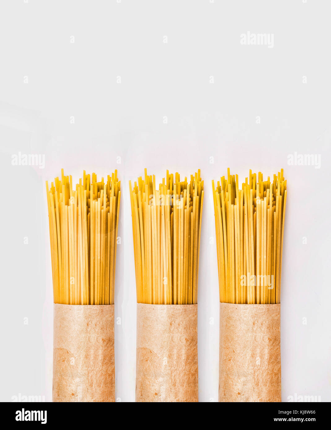 Spaghetti packed into paper on a white background. Supermarket. top ...