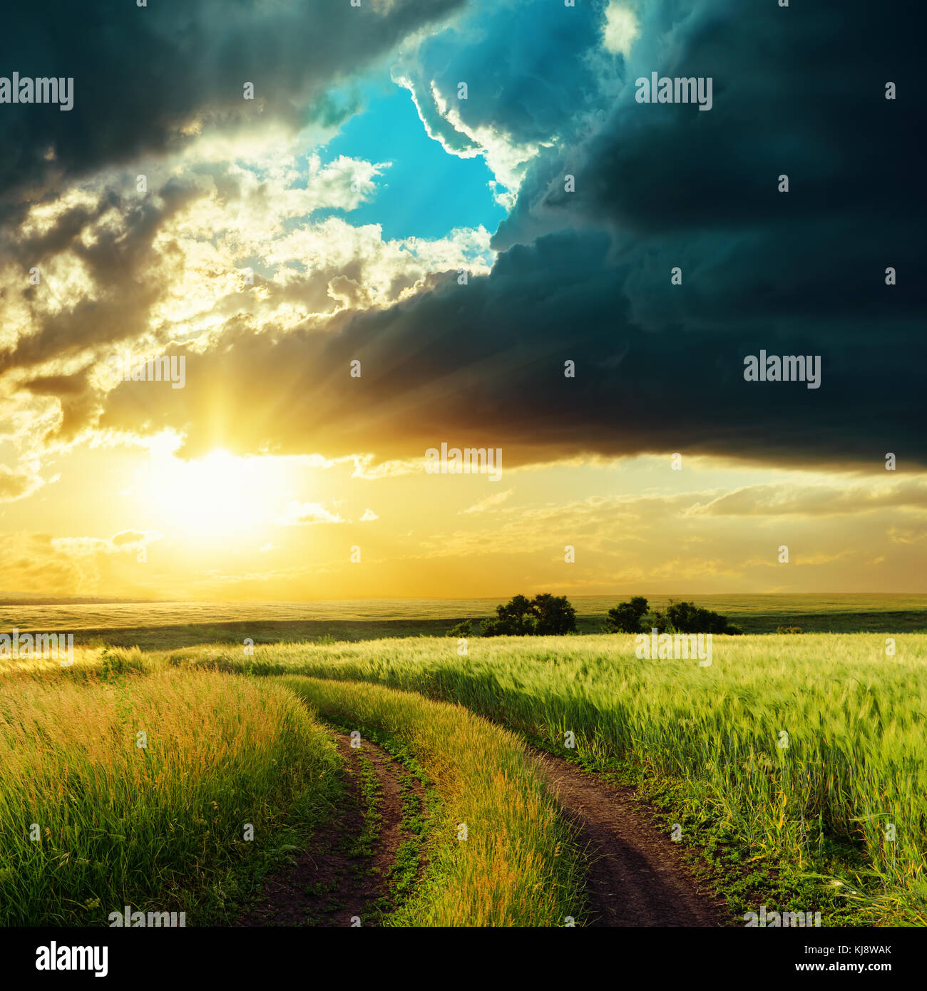 field road and dramatic sunset over it Stock Photo - Alamy