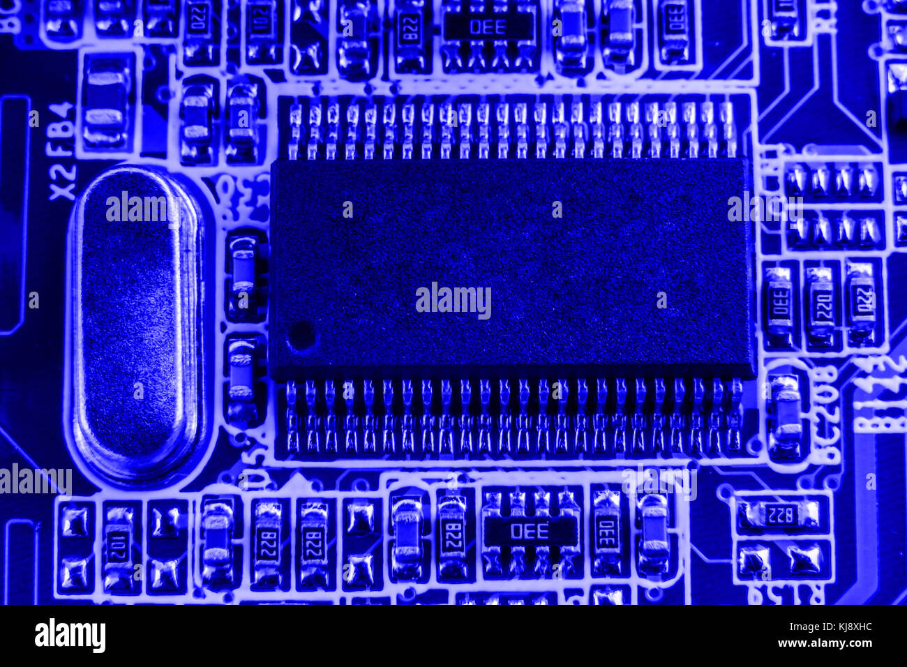 Integrated semiconductor microchip on blue circuit board representative ...