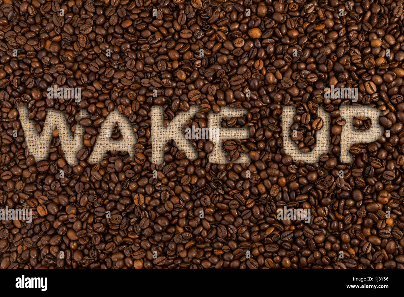 Wake up concept written on coffee beans and jute canvas fabric sack ...