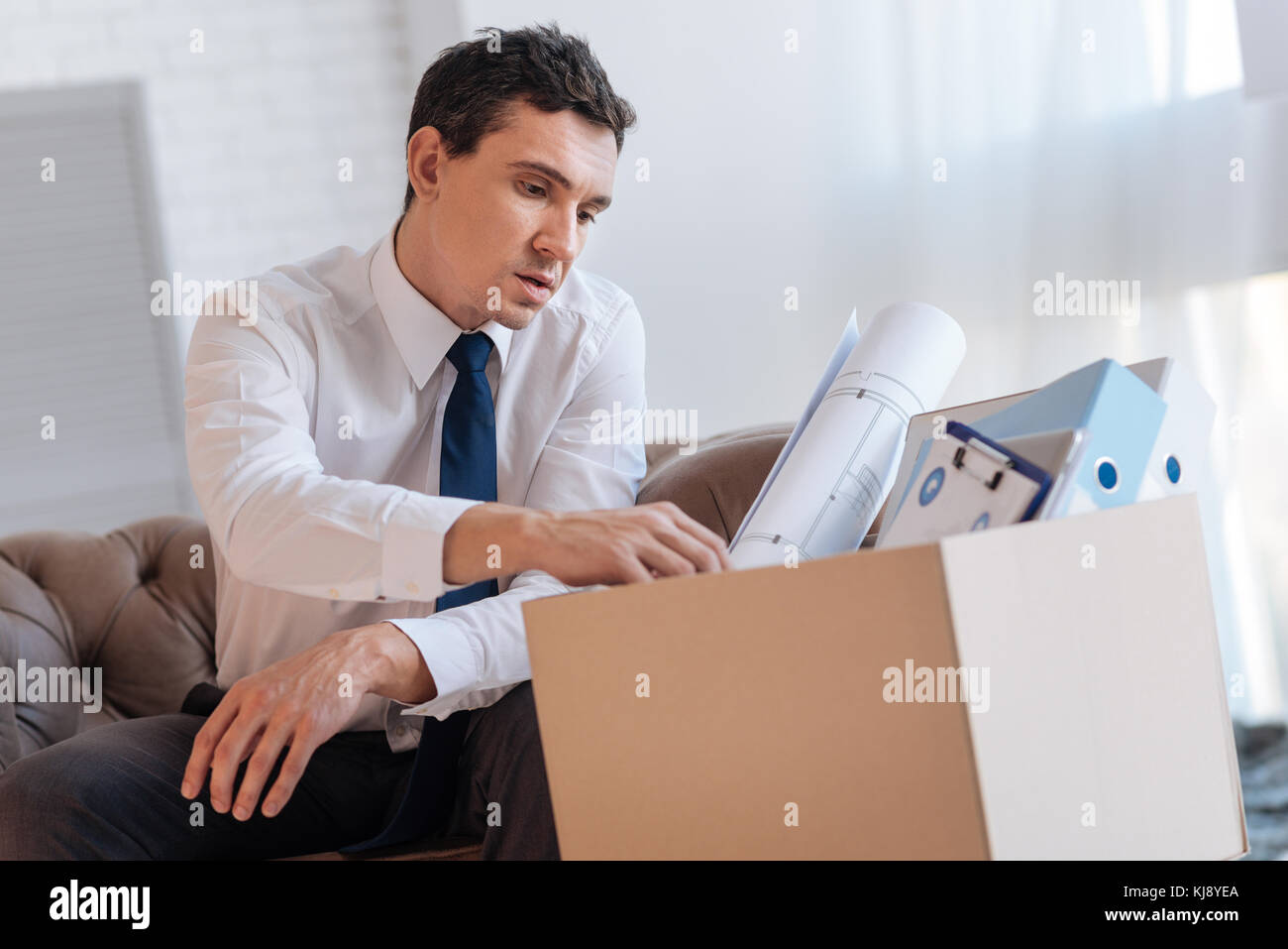 Curious young man touching different things in a big box Stock Photo ...