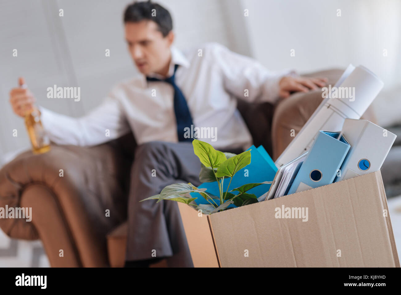 Young desperate man drinking alcohol after losing his job Stock Photo ...