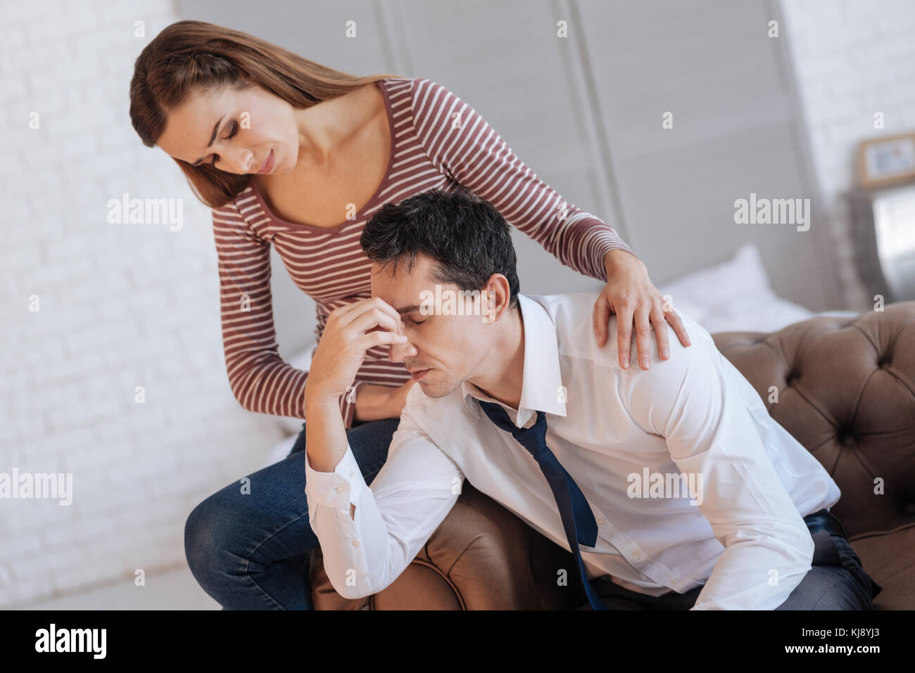 Loving young woman helping her depressed husband Stock Photo - Alamy