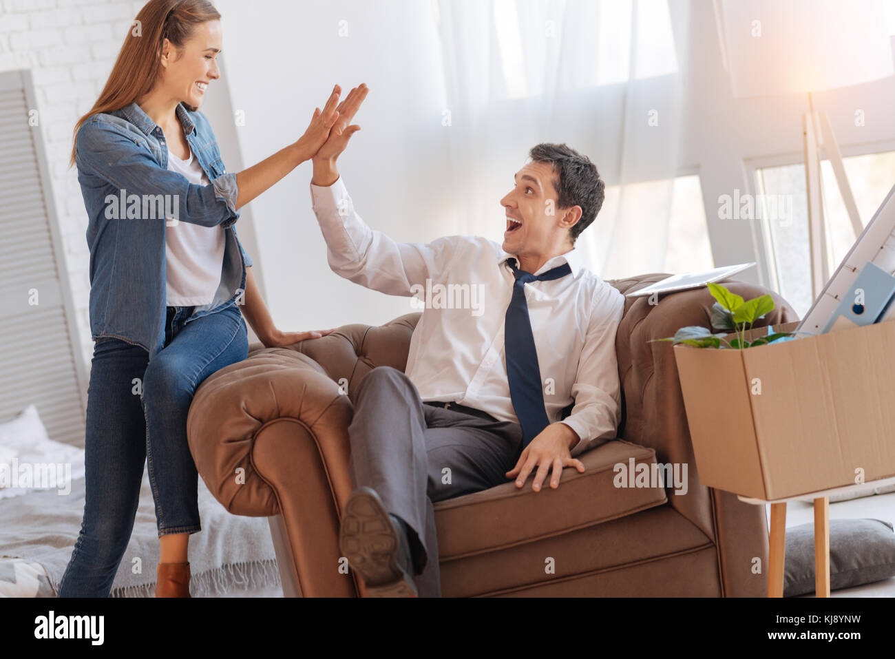 Cheerful pretty woman greeting her emotional excited husband Stock ...