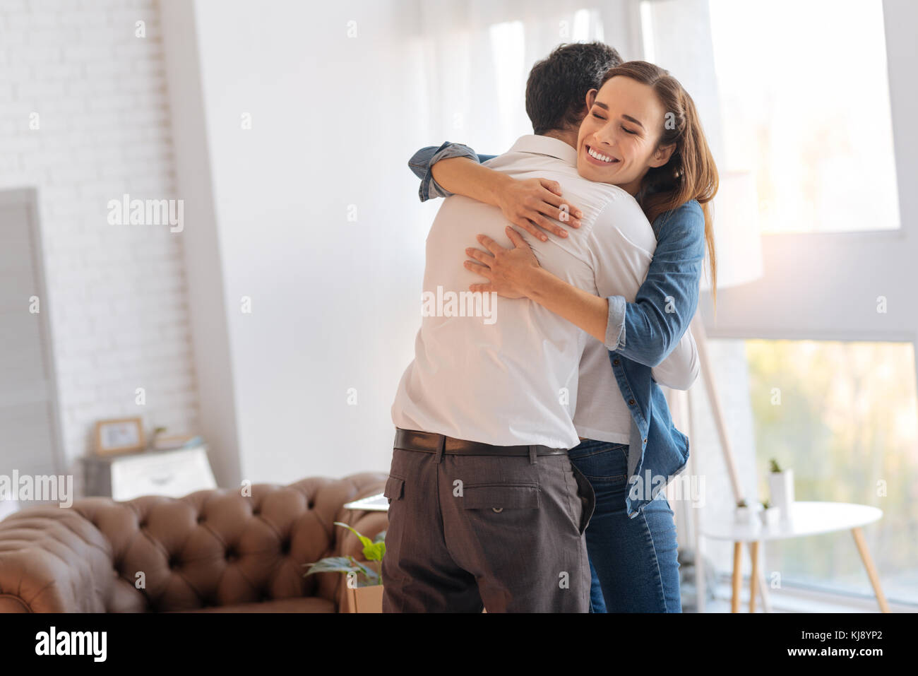 Excited loving wife hugging her kind supporting husband Stock Photo - Alamy