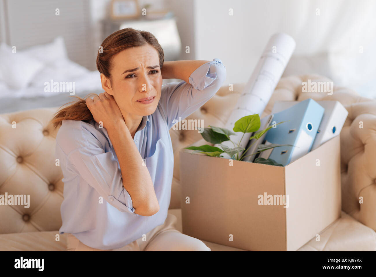 Emotional desperate woman crying while sitting on the sofa Stock Photo ...